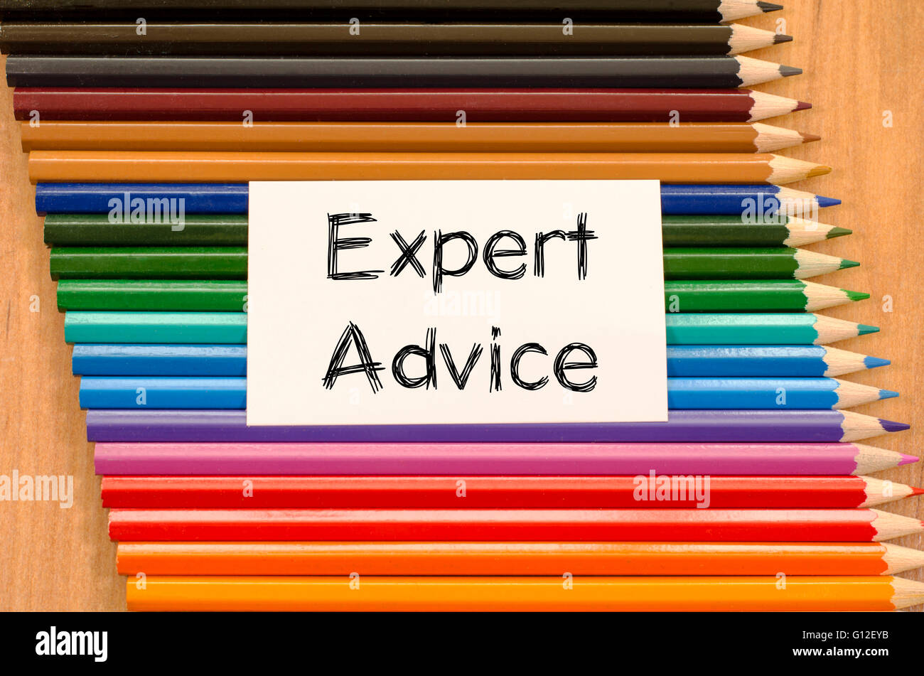 Expert advice text concept and colored pencil on wooden background ...
