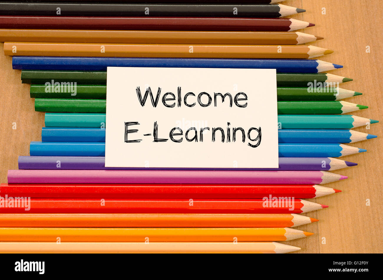Welcome e-learning text concept and colored pencil on wooden background ...