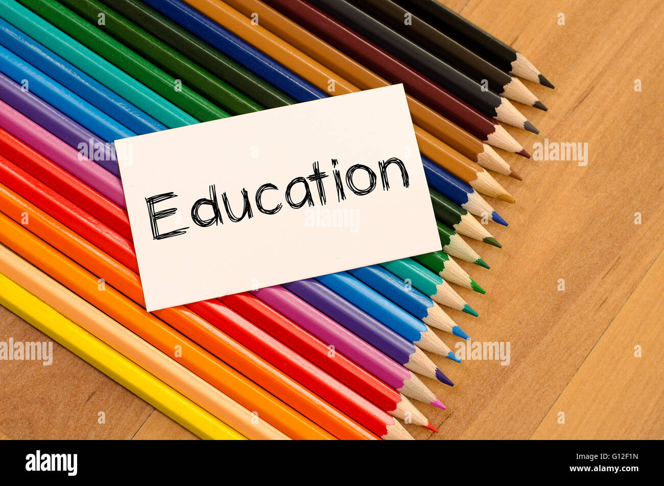 Education text concept and colored pencil on wooden background Stock ...
