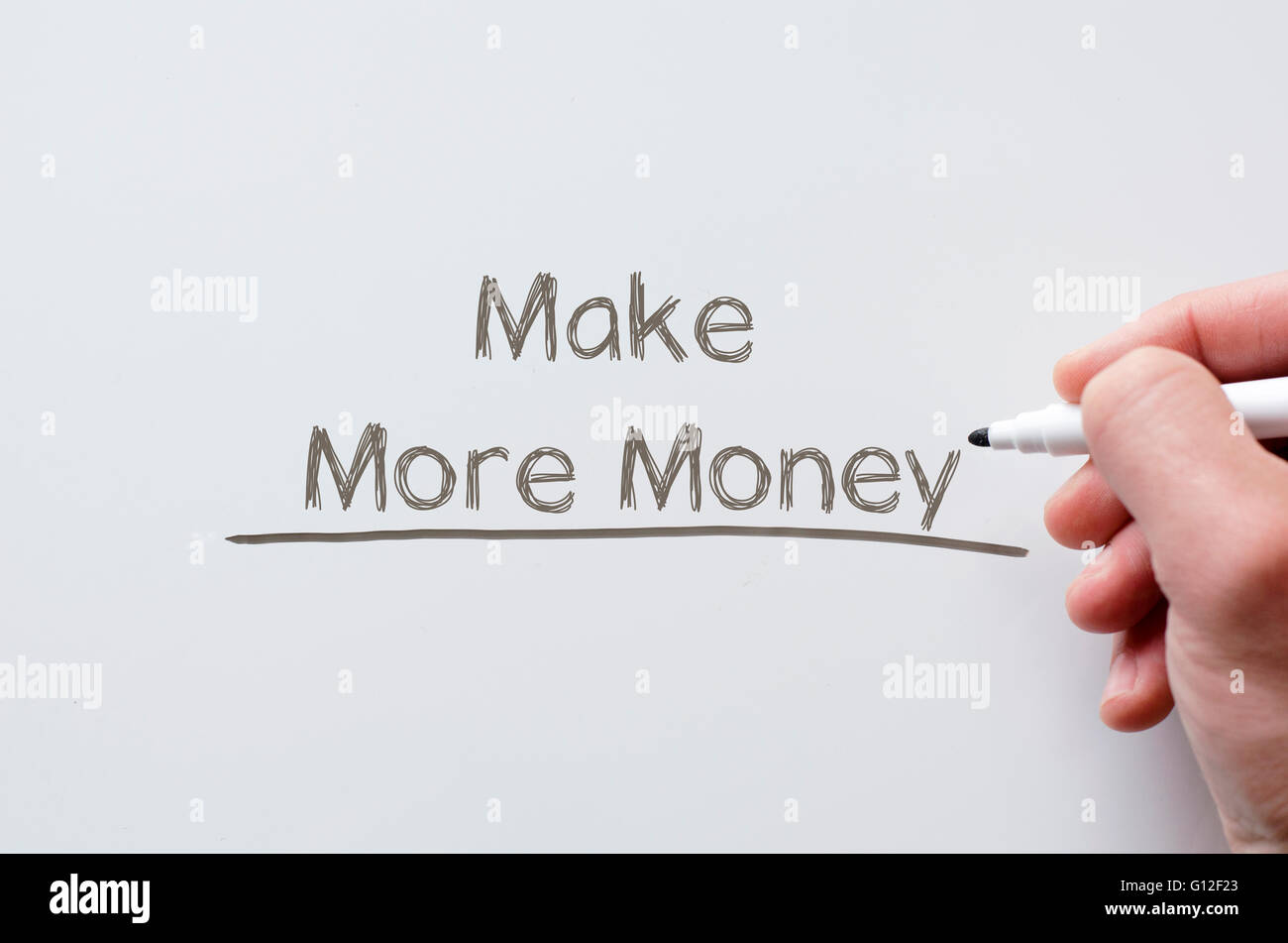 Human hand writing make more money on whiteboard Stock Photo - Alamy