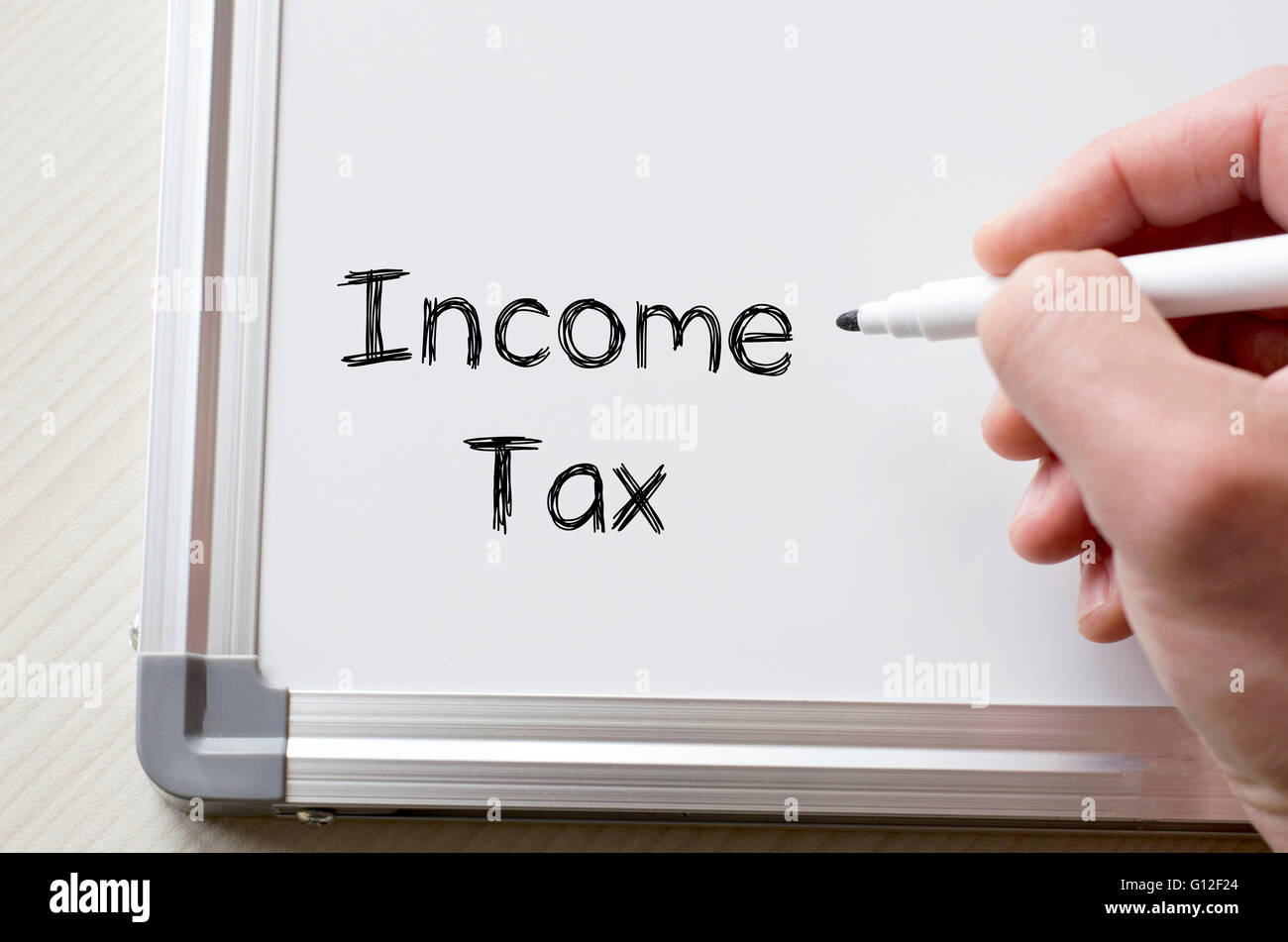 Human hand writing income tax on whiteboard Stock Photo - Alamy