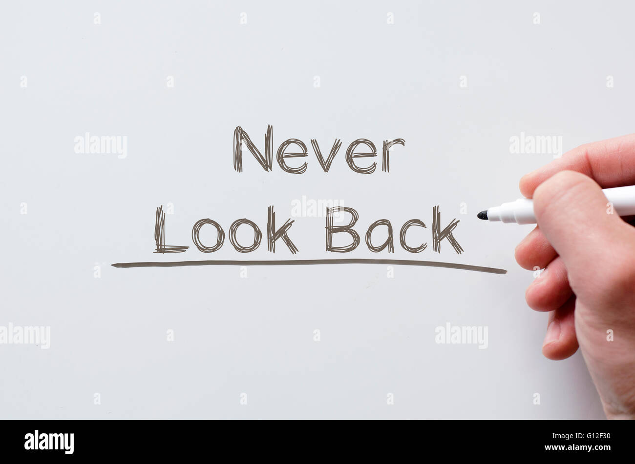 Human hand writing never look back on whiteboard Stock Photo - Alamy