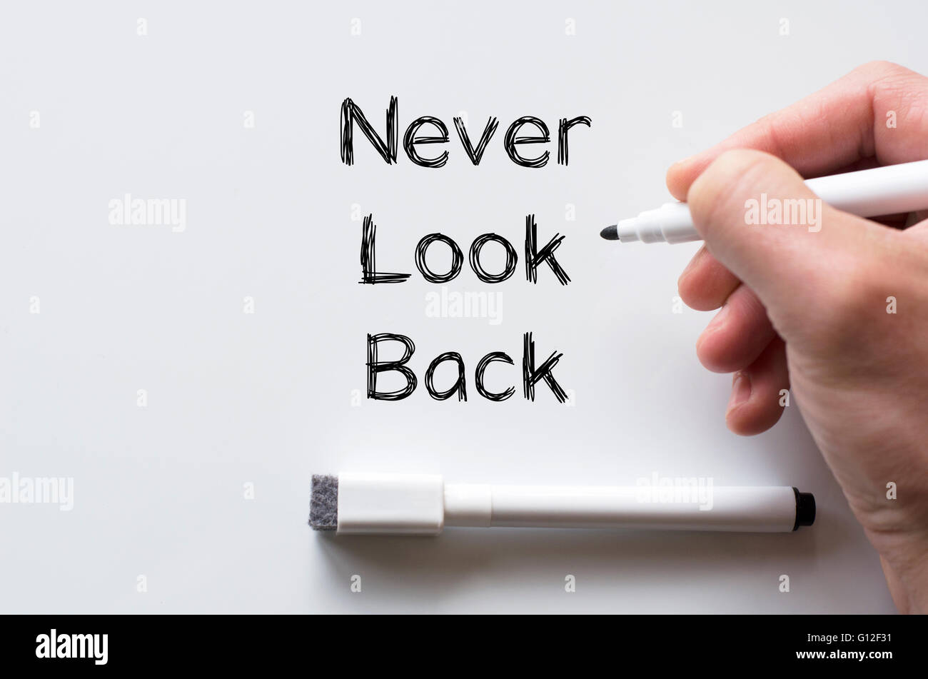 Human hand writing never look back on whiteboard Stock Photo - Alamy