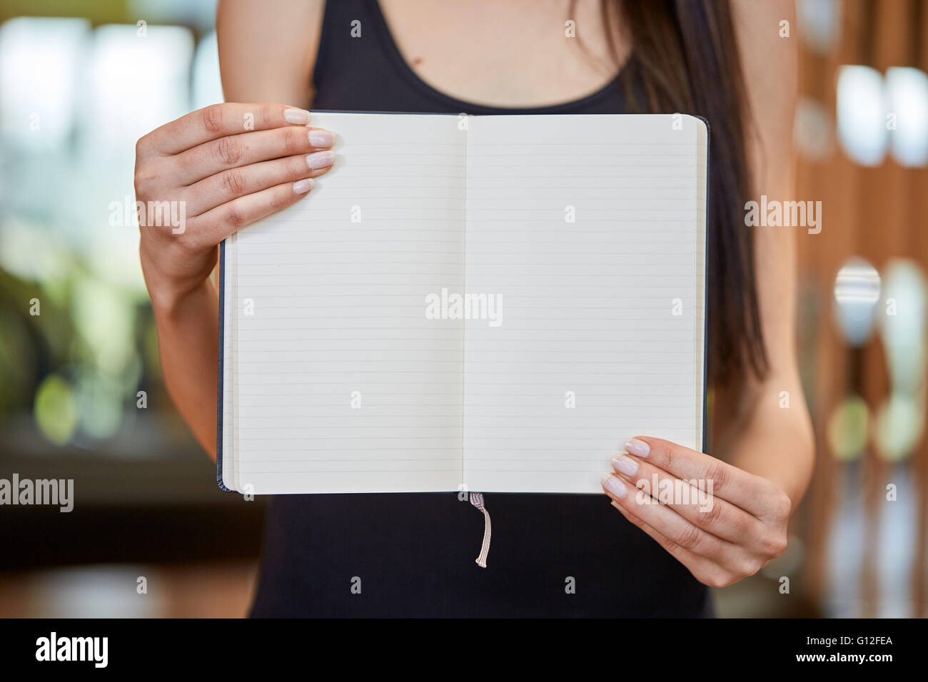 Young caucasian woman holding and showing book with white pages Stock ...