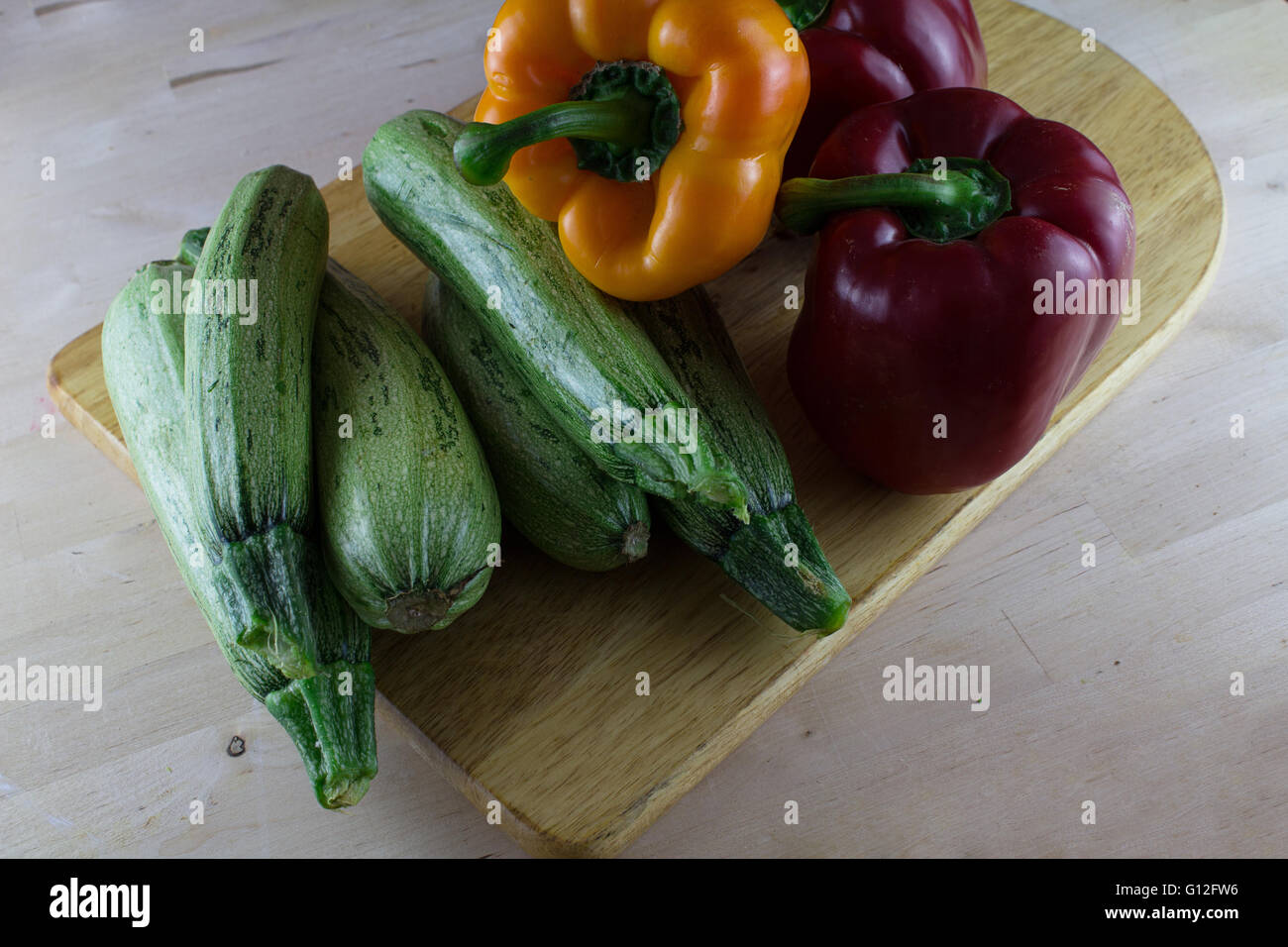 A group of fresh Mediterranean vegetables, as courgettes and red and ...
