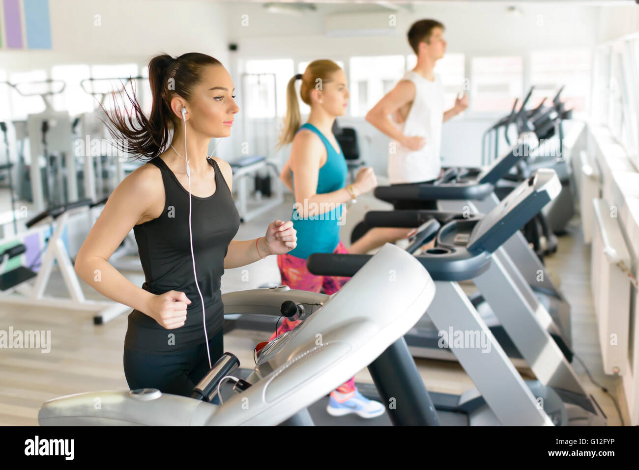 People running on treadmill at gym Stock Photo - Alamy