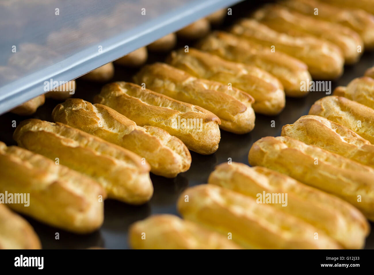 Rows of yellow eclair shells Stock Photo - Alamy