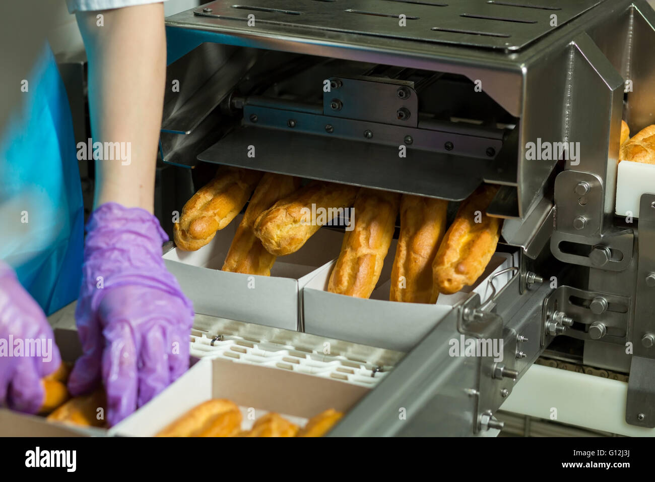 Boxes of eclairs on conveyor Stock Photo - Alamy