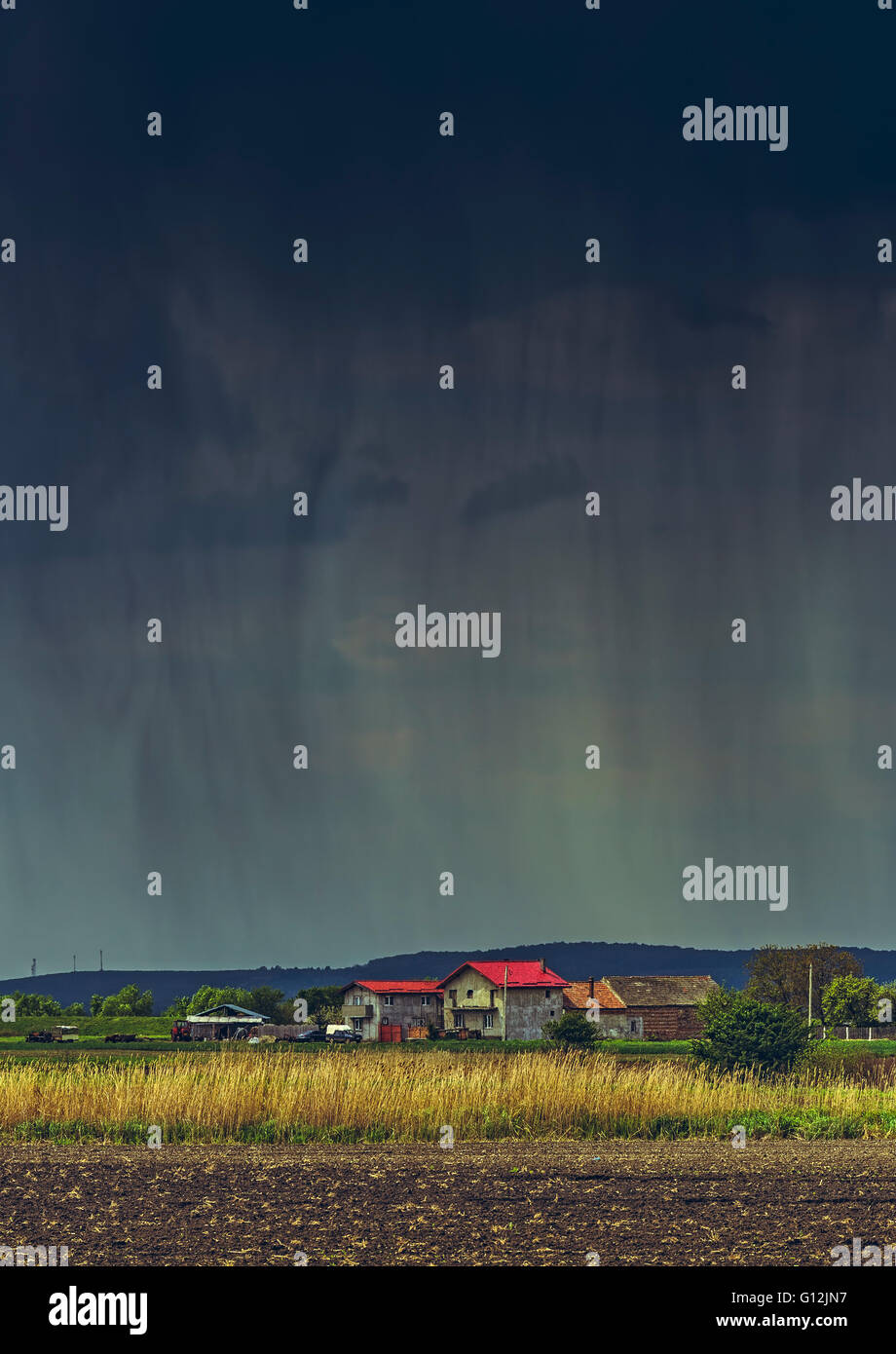 Heavy torrential rain pouring down a village in Transylvania region ...