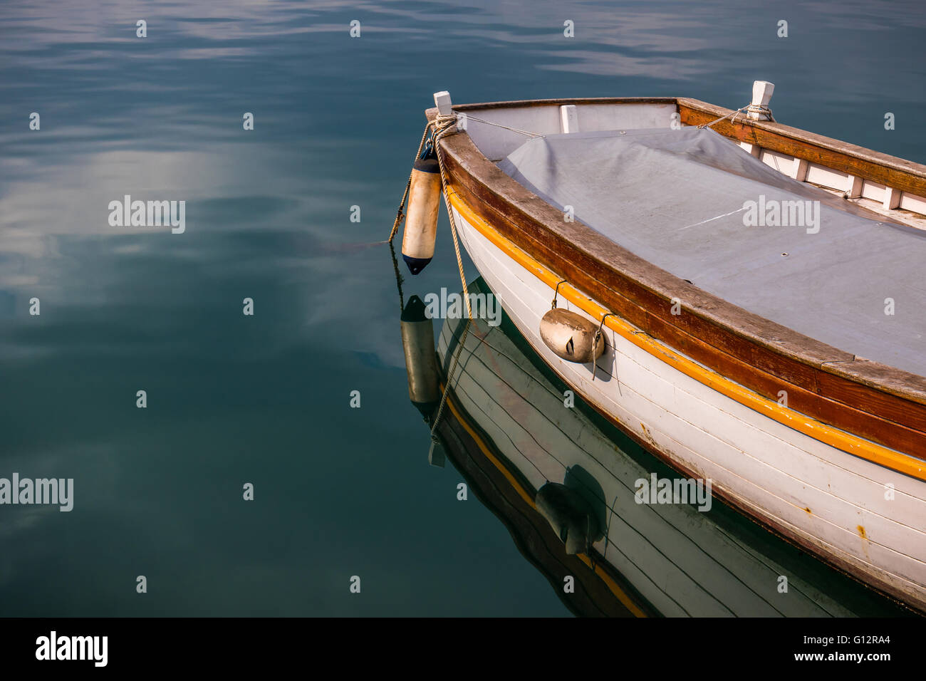 Old boat reflecting in the water Stock Photo - Alamy