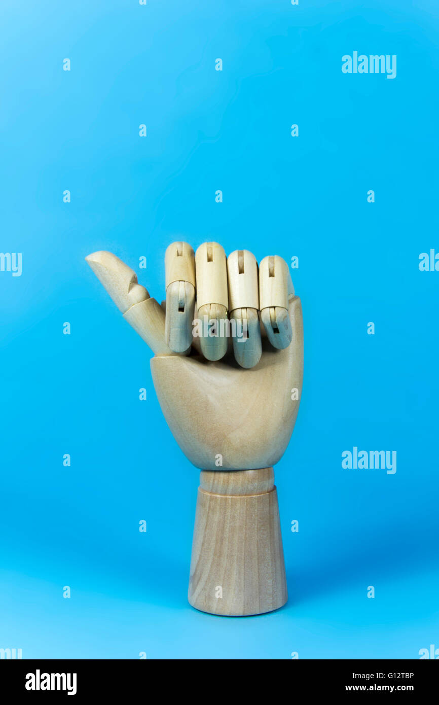hand wood, wooden hand, one finger, blue background Stock Photo - Alamy