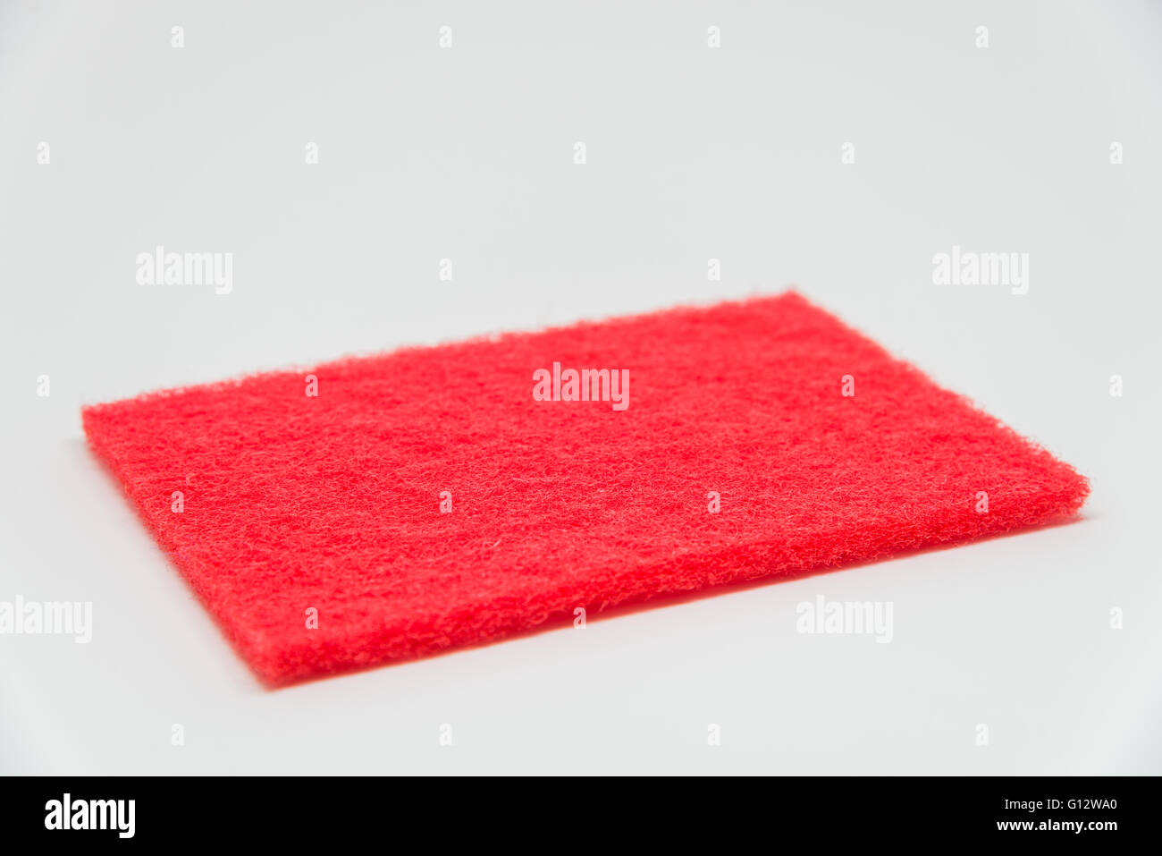 Red Scouring pad with white background and selective focus Stock Photo ...