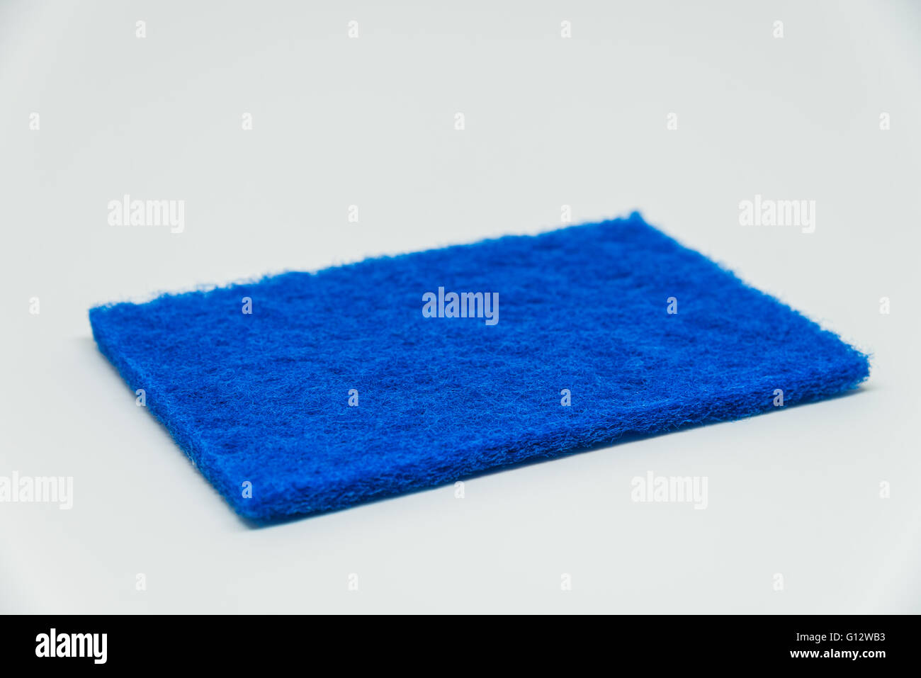 Blue Scouring pad with white background and selective focus Stock Photo ...