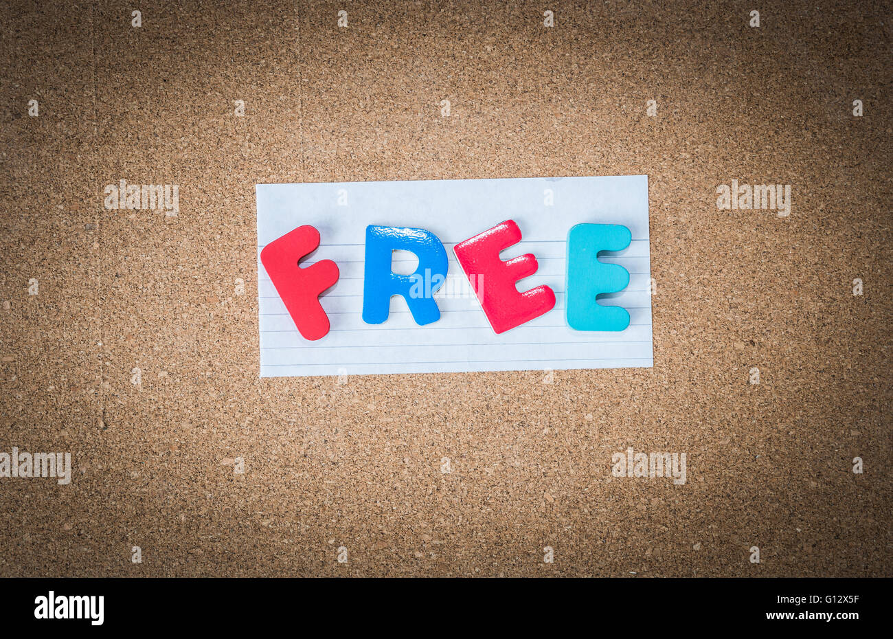 Colorful Wooden word FREE on paper and cork board Stock Photo - Alamy