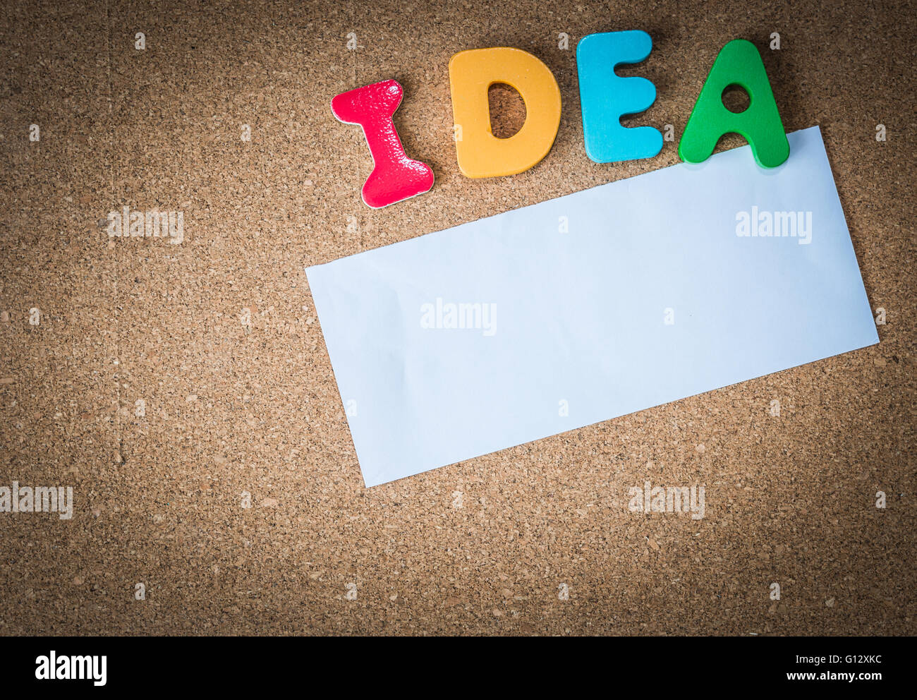 Colorful Wooden word IDEA with piece of White paper on cork board Stock ...