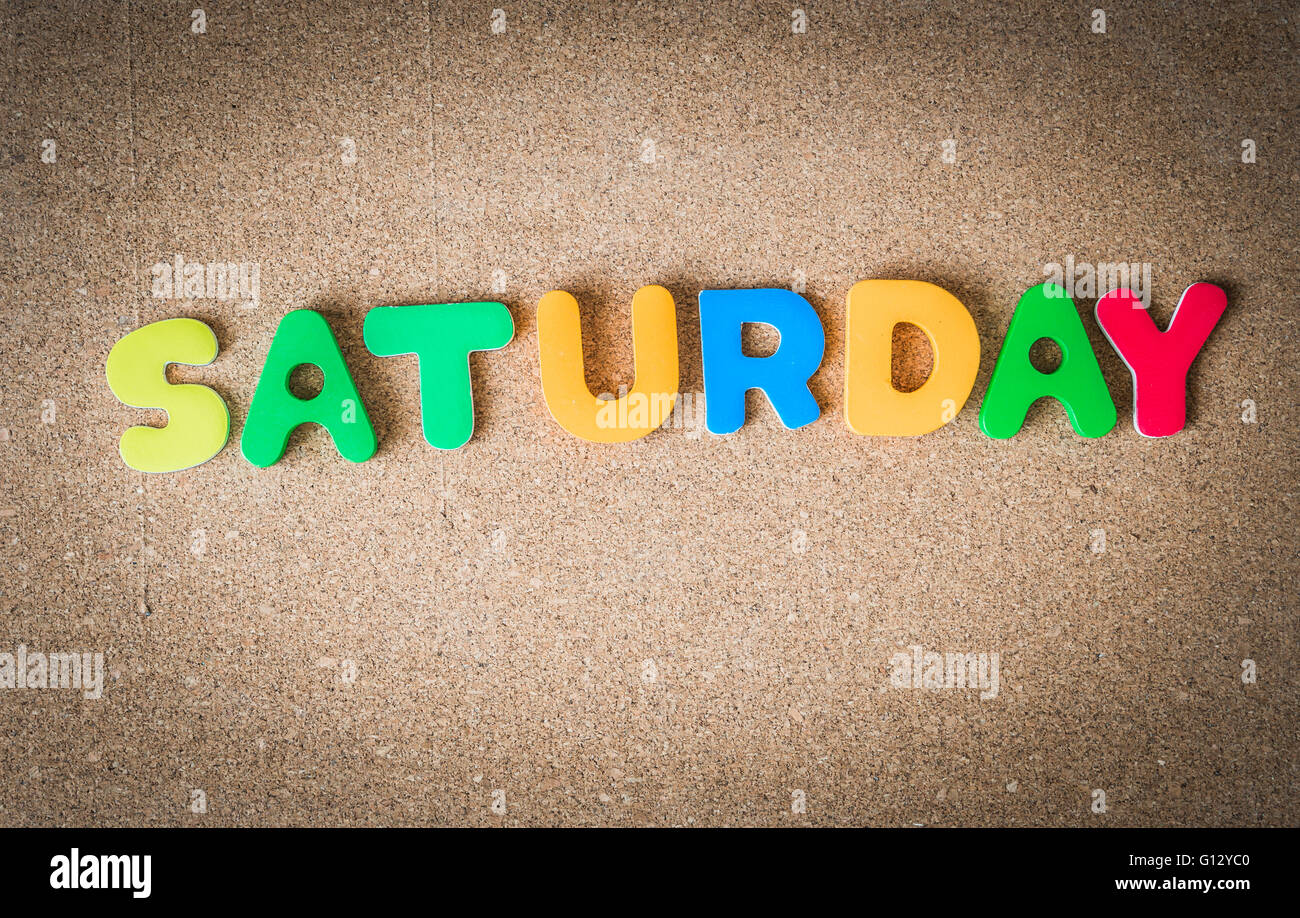 Colorful wooden word SATURDAY on Cork board with selective focus Stock ...