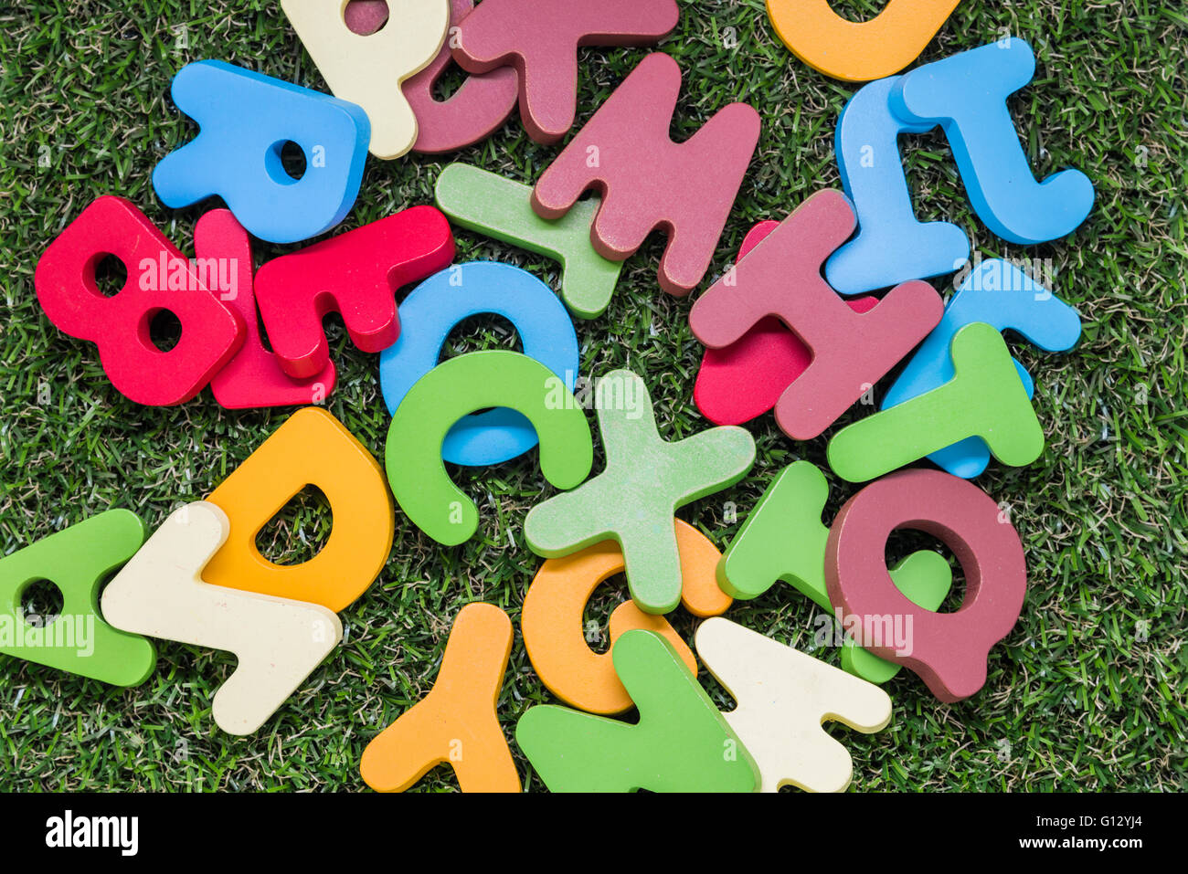 Colorful wooden alphabet on green grass Stock Photo - Alamy