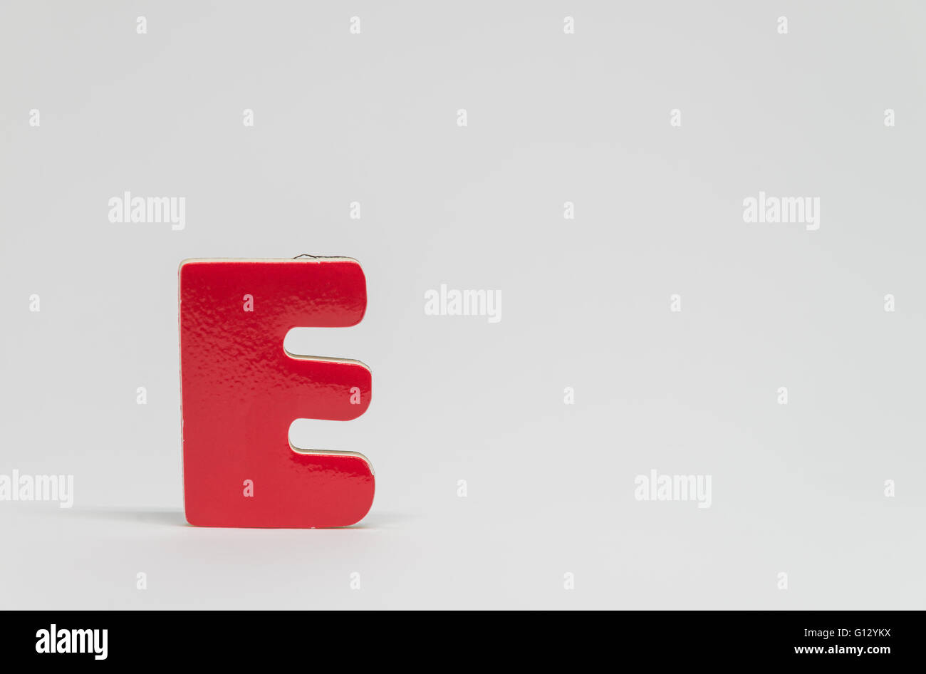 Red wooden alphabet E with white background and selective focus Stock ...