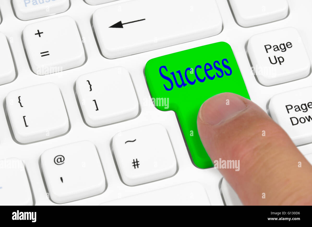 Success concept. Pressing the Success button on a white computer ...