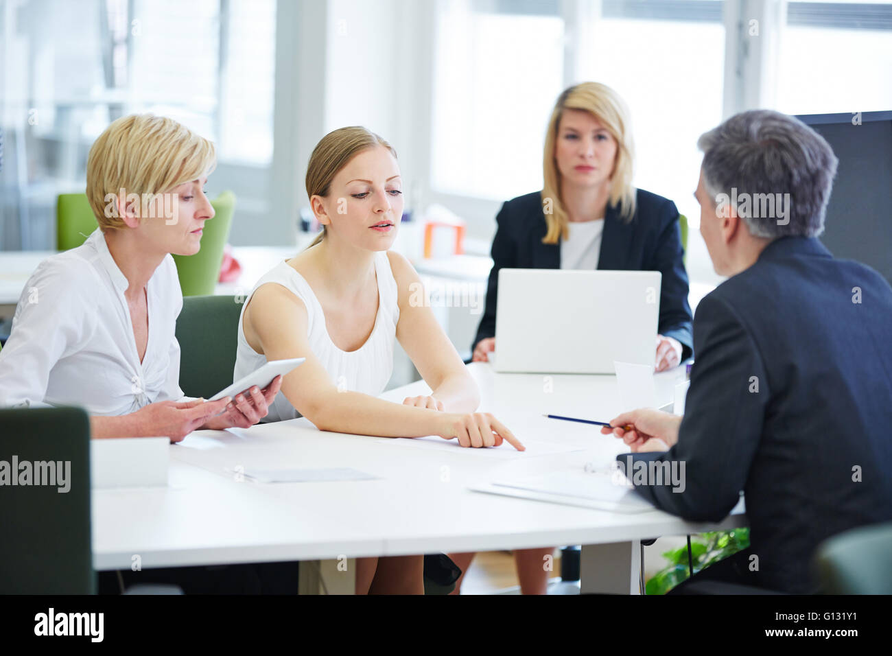 Negotiation in business team meeting in the office Stock Photo - Alamy