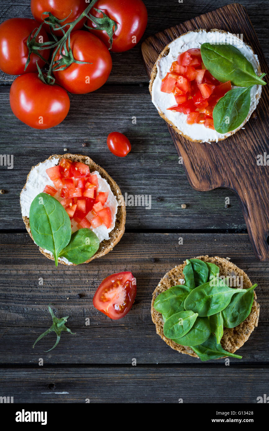 Healthy snack: rye flatbread with cheese spread, tomatoes and baby ...