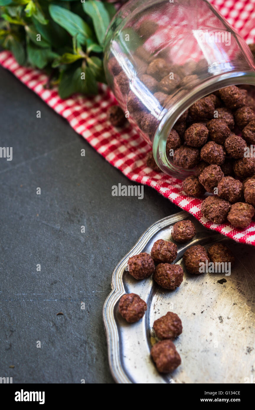 Chocolate breakast flakes with yogurt and mint in vintage glass on ...