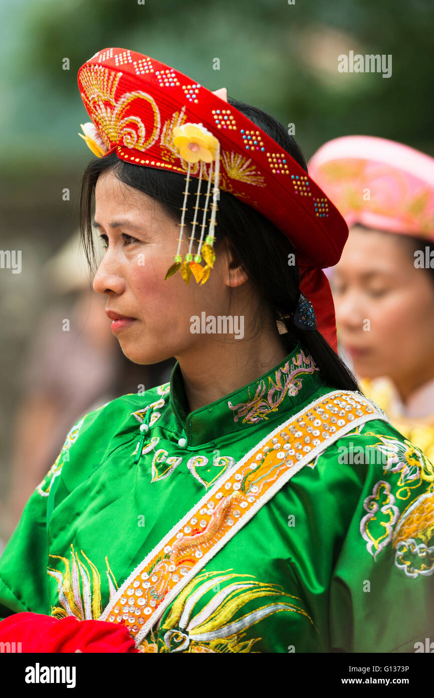 Woman in traditional dress for a ceremony during the Truong Yen ...