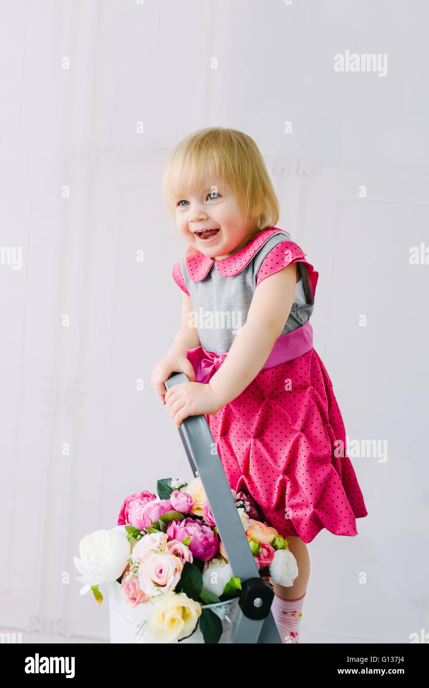 The girl on the stairs with flowers Stock Photo - Alamy