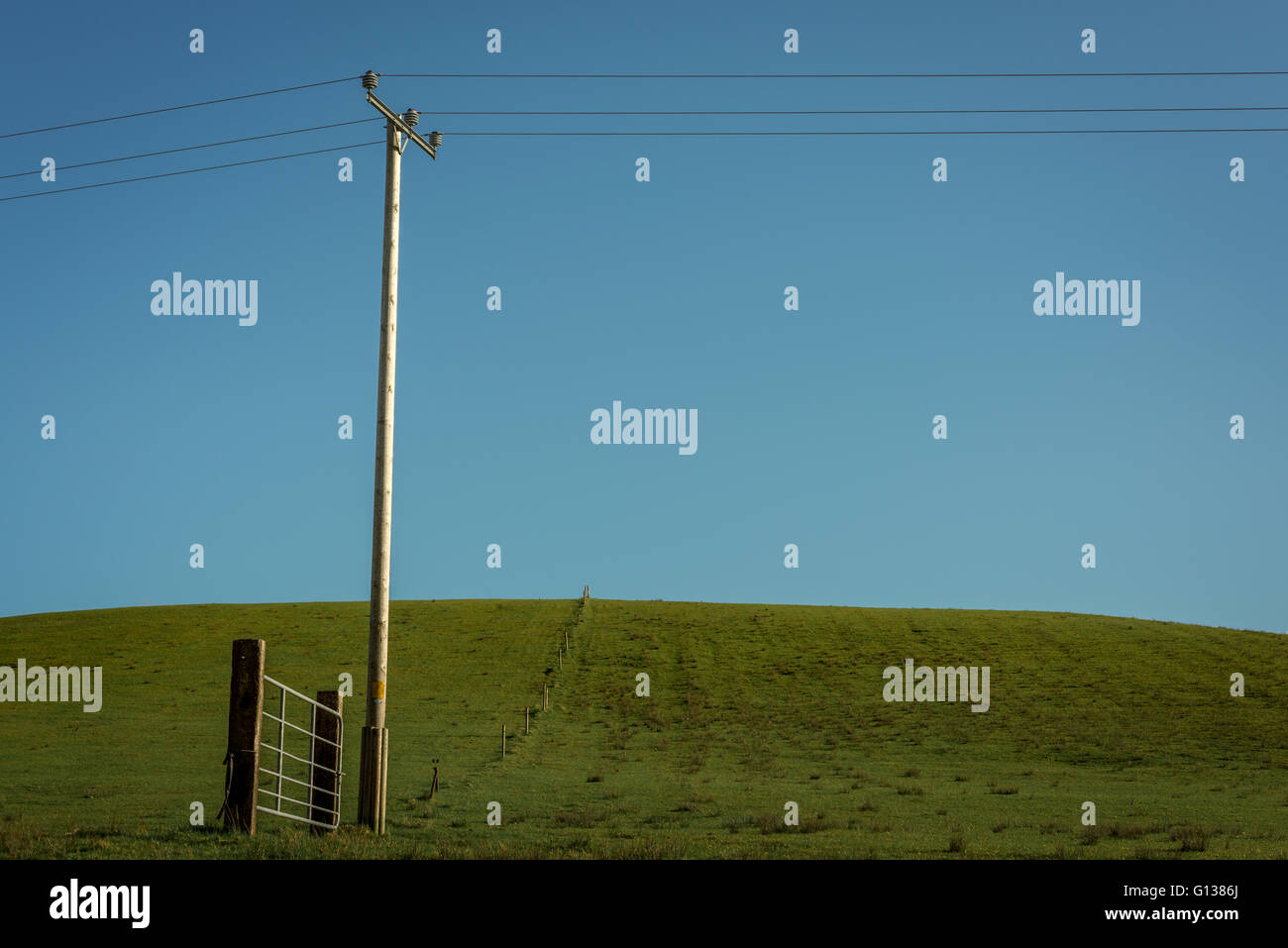 Simple wooden power lines pole and overhead electrical power lines in ...