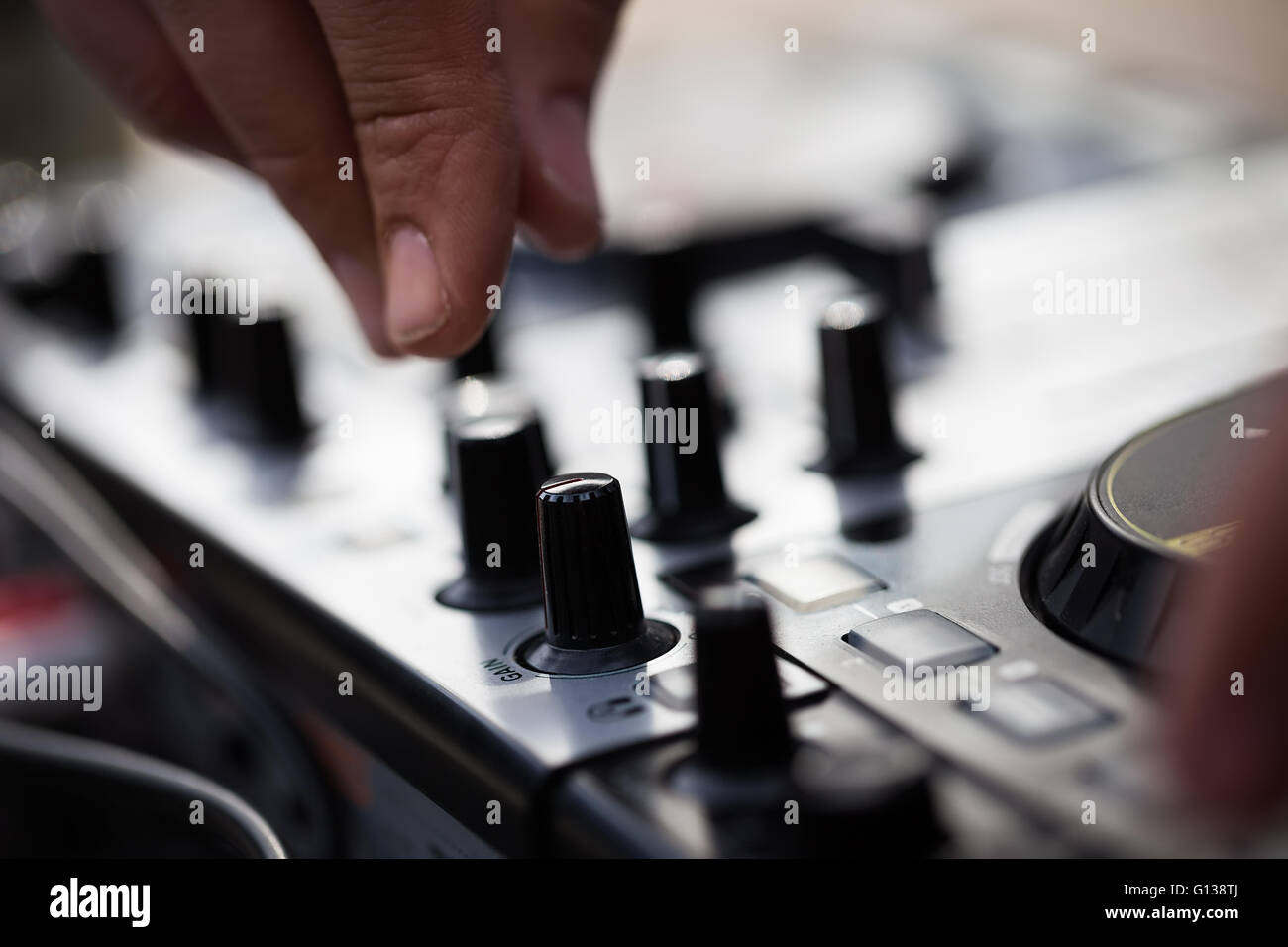 Hands of male Dj playing music on modern midi controller turntable ...