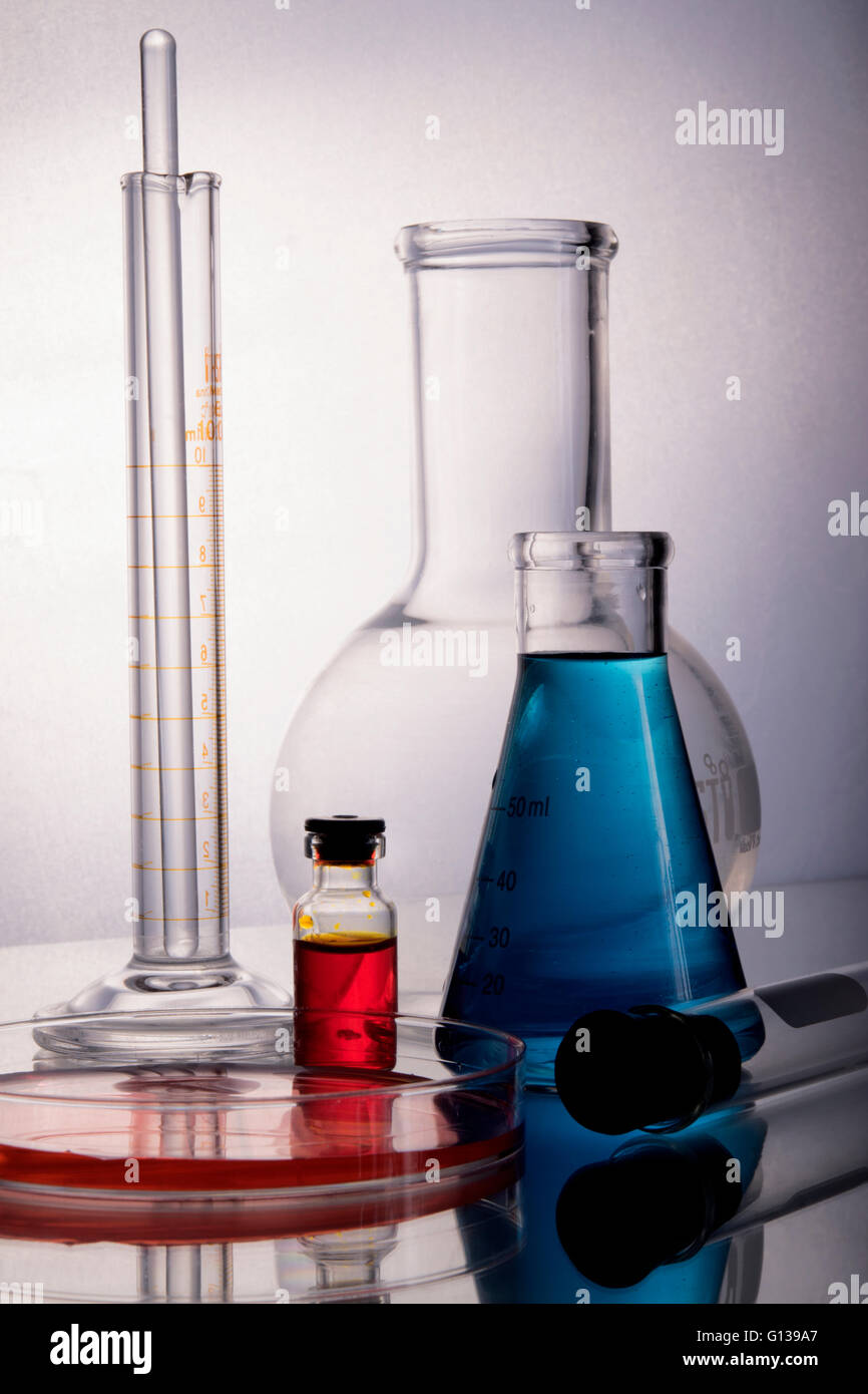 chemistry lab with flasks, vial, graduated cylinder and petri dish ...