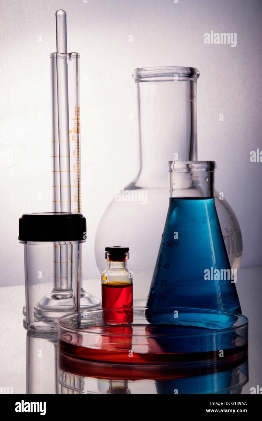 chemistry lab with flasks, vial, graduated cylinder and petri dish ...