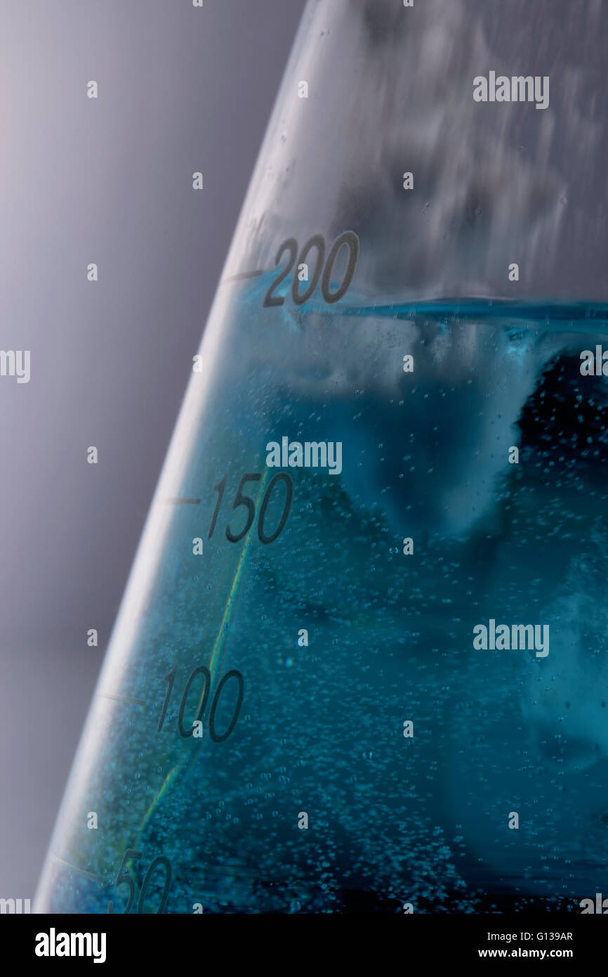 Erlenmeyer flask close up with chemical reaction fizzing Stock Photo ...