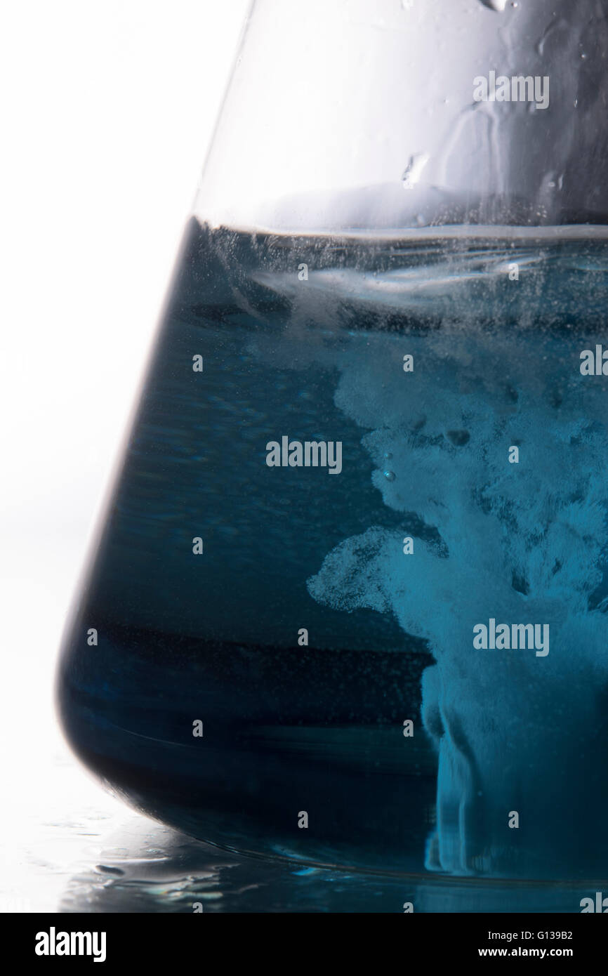 Erlenmeyer flask close up with chemical reaction fizzing Stock Photo ...