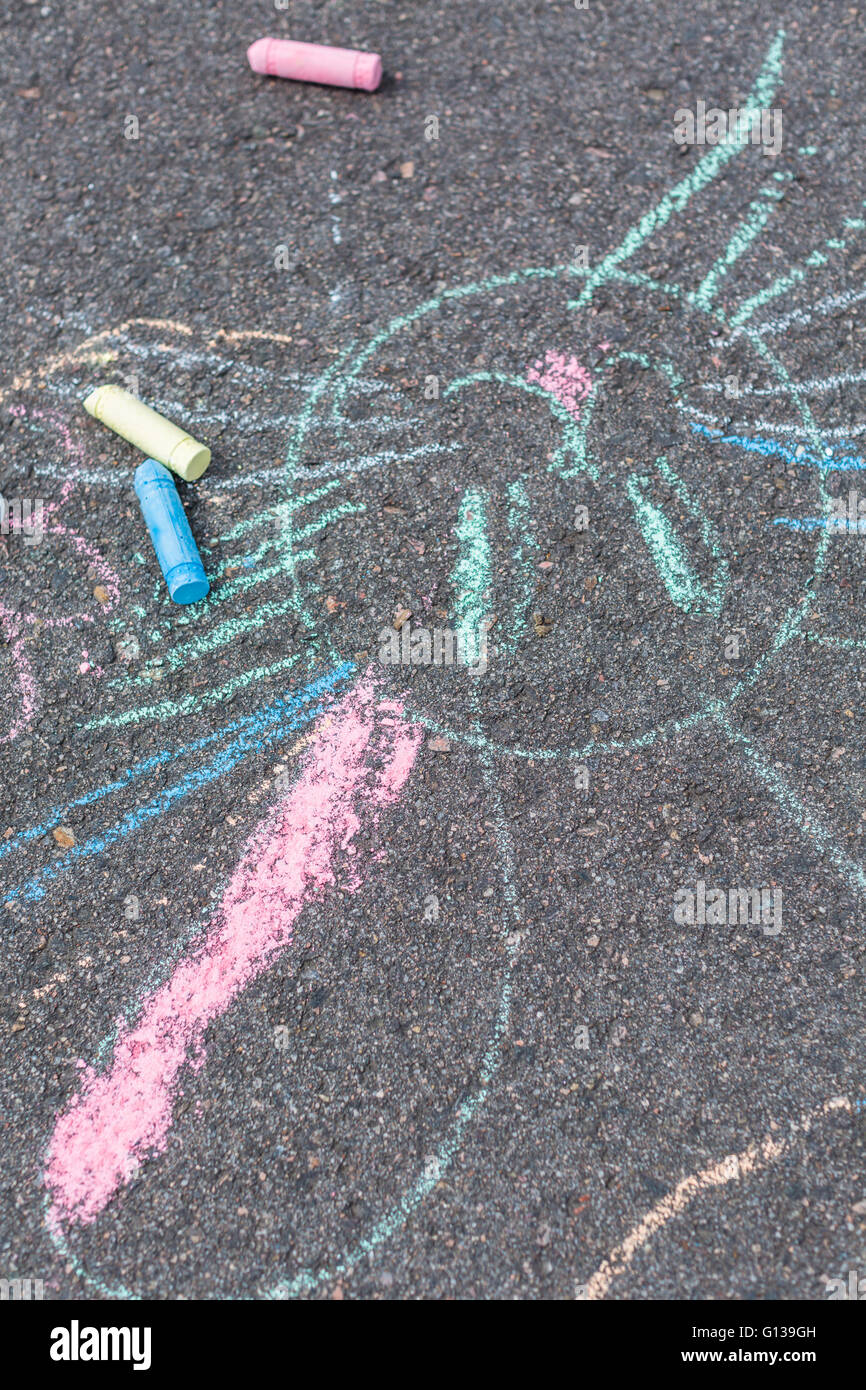 Kids chalk art on black pavement Stock Photo - Alamy
