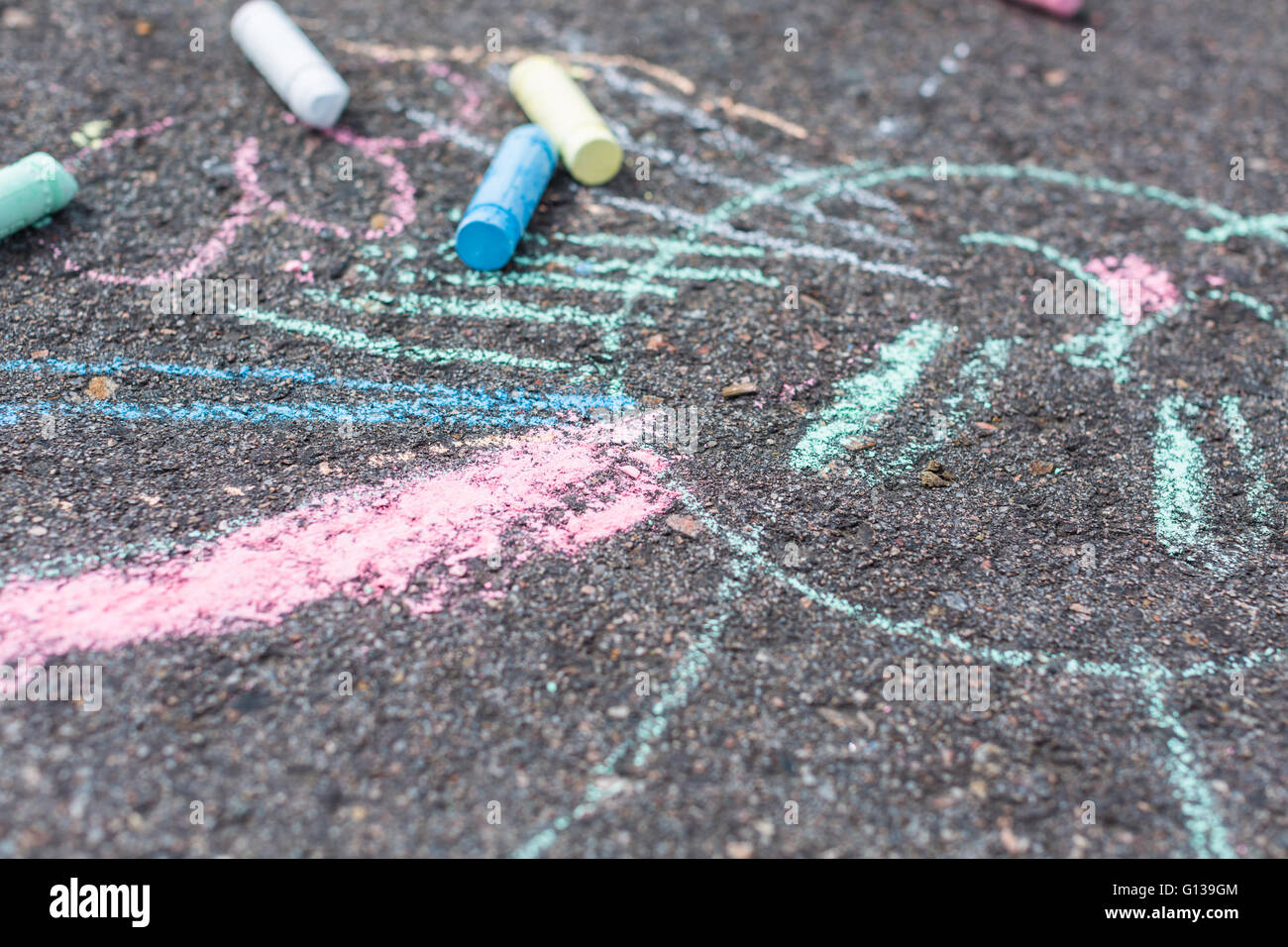 Kids chalk art on black pavement Stock Photo - Alamy