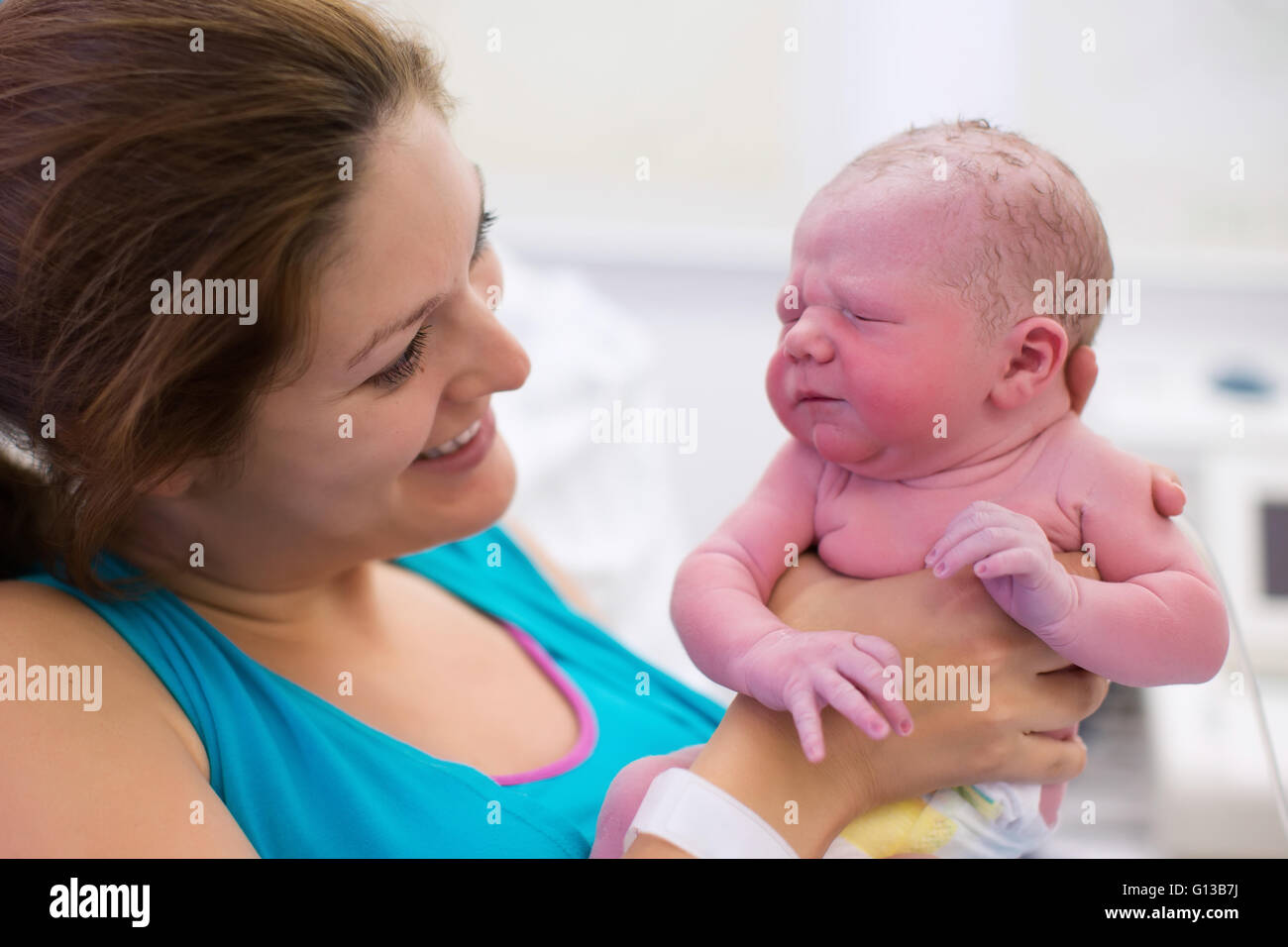 Mother giving birth to a baby. Newborn baby in delivery room. Mom ...