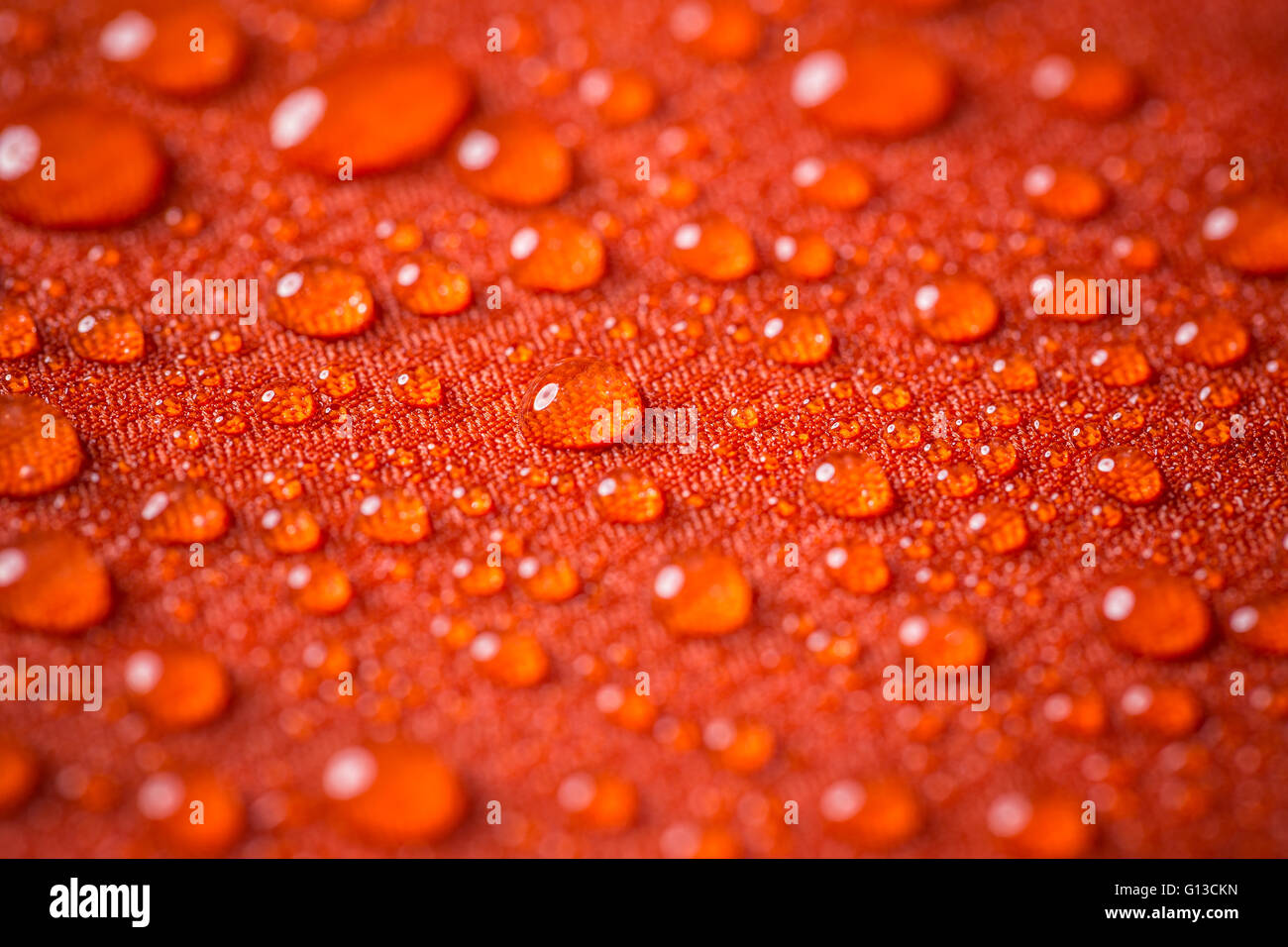 Red waterproof coating background with water drops Stock Photo - Alamy