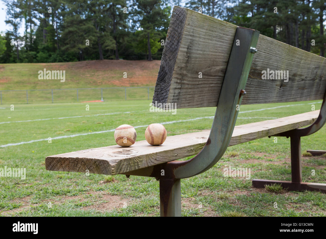Baseball on a bench in a little league field Stock Photo - Alamy