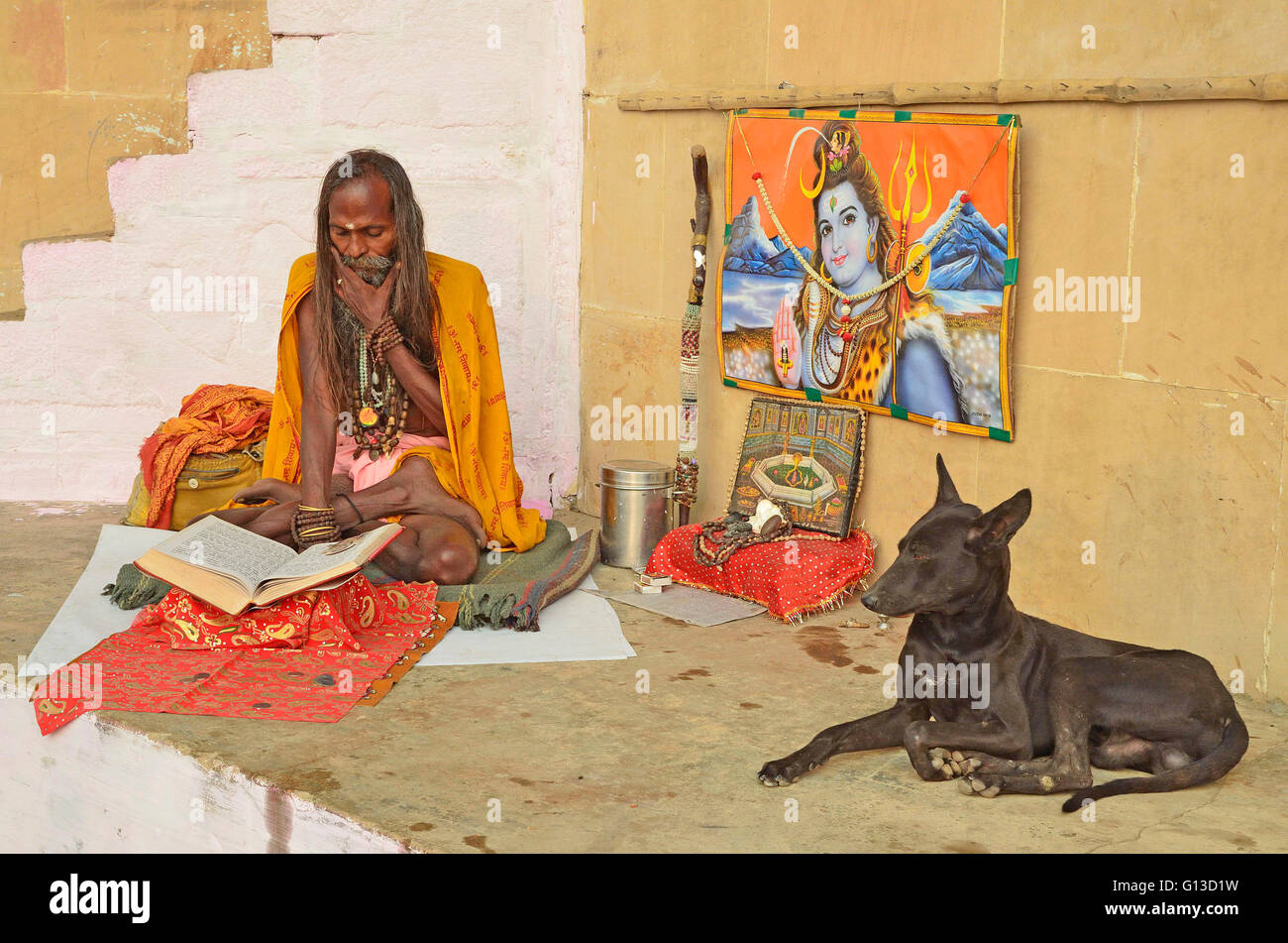 A Sadhu or Hindu saint reading the holy Gita with an image of Lord ...
