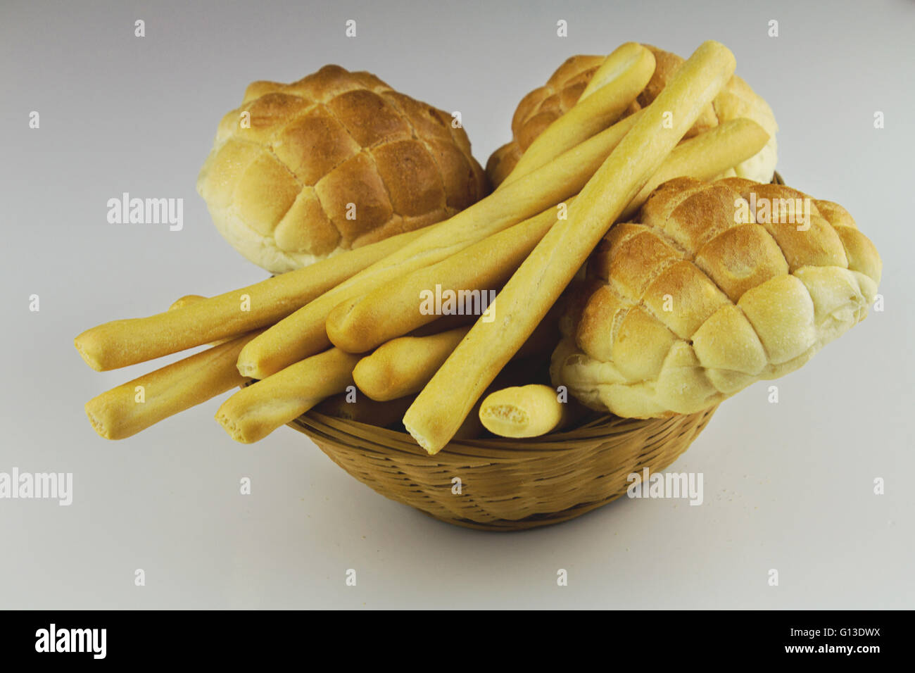 Golden bread and breadsticks in the basket on white background Stock ...