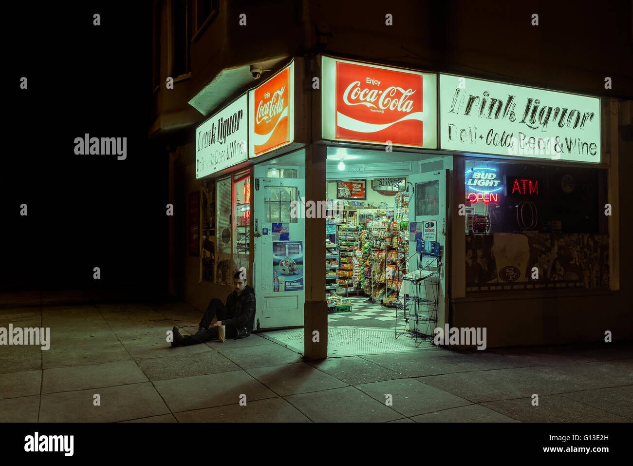 Man at night on a liquor store Stock Photo - Alamy