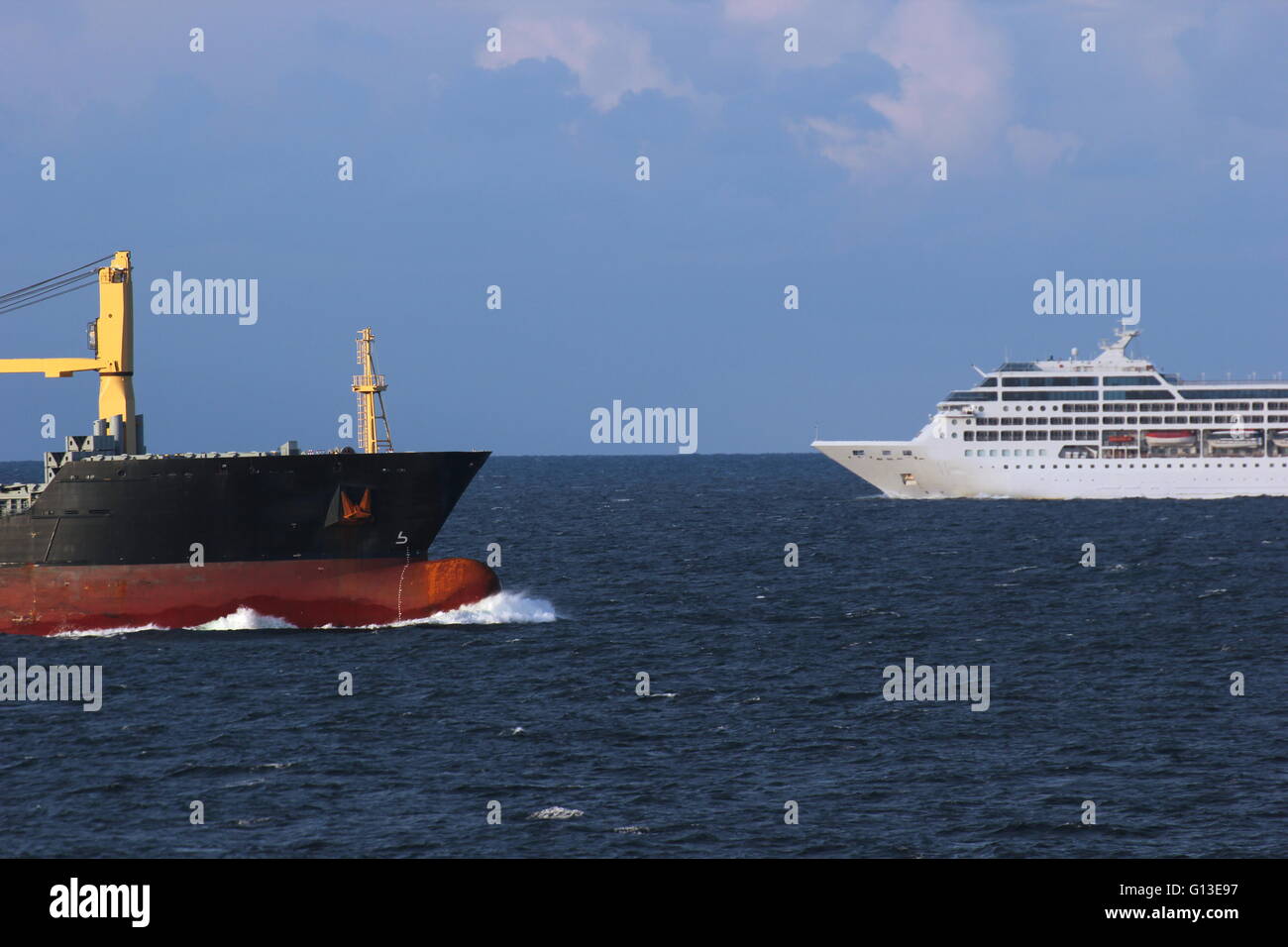 Ferry and freight ship facing in open waters Stock Photo - Alamy