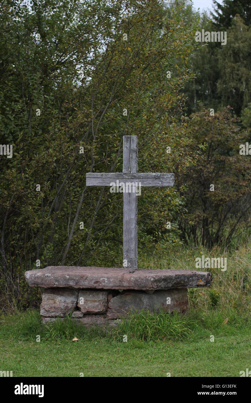 Simple wooden cross and stone altar outdoors Stock Photo - Alamy