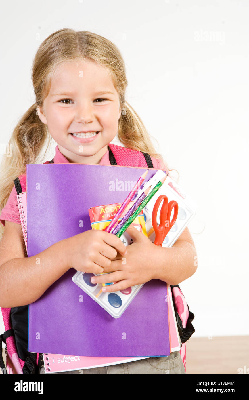 Little girl with school supplies, doing homework, etc Stock Photo - Alamy