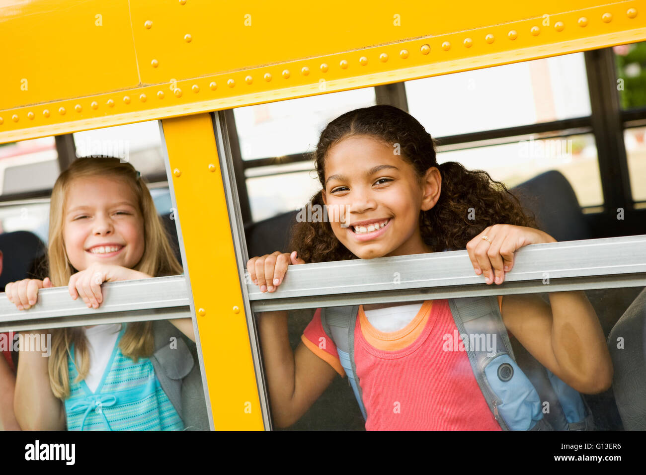 Series with elementary aged students and a school bus Stock Photo - Alamy