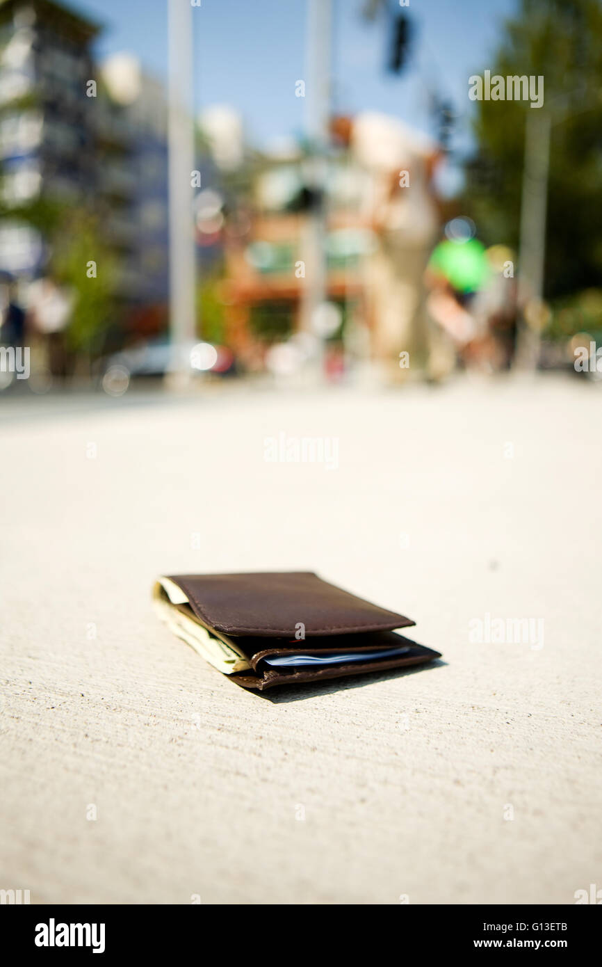 Man loses wallet on city street Stock Photo - Alamy