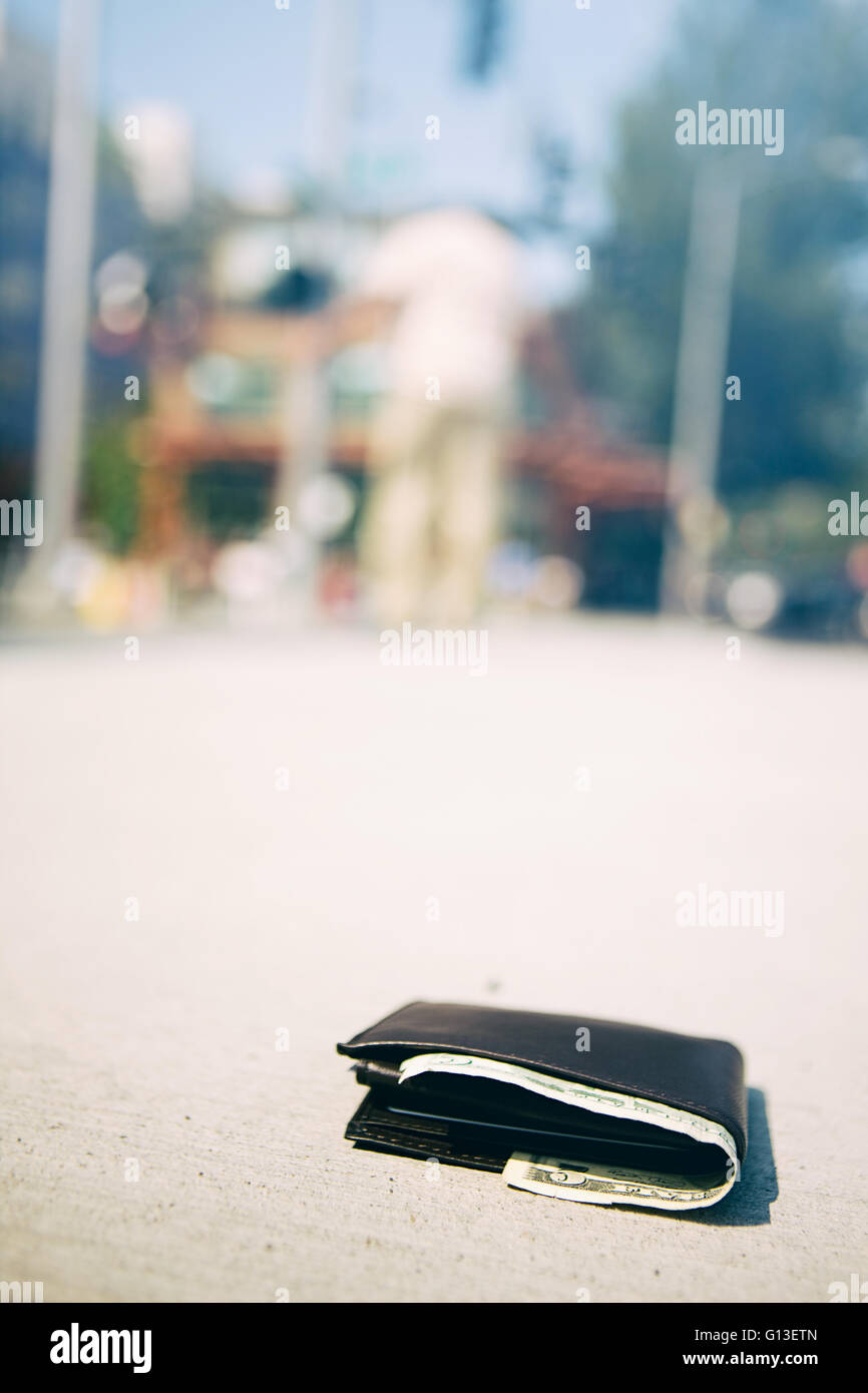 Man loses wallet on city street Stock Photo - Alamy
