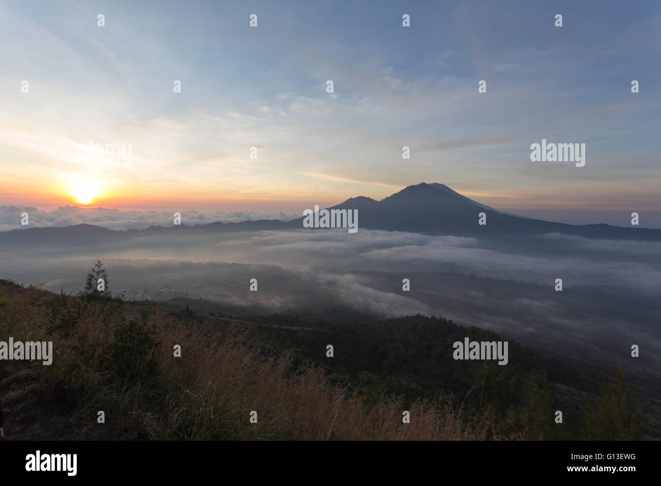 Sunrise above clouds with a mountain volcano view Mt Batur Bali ...