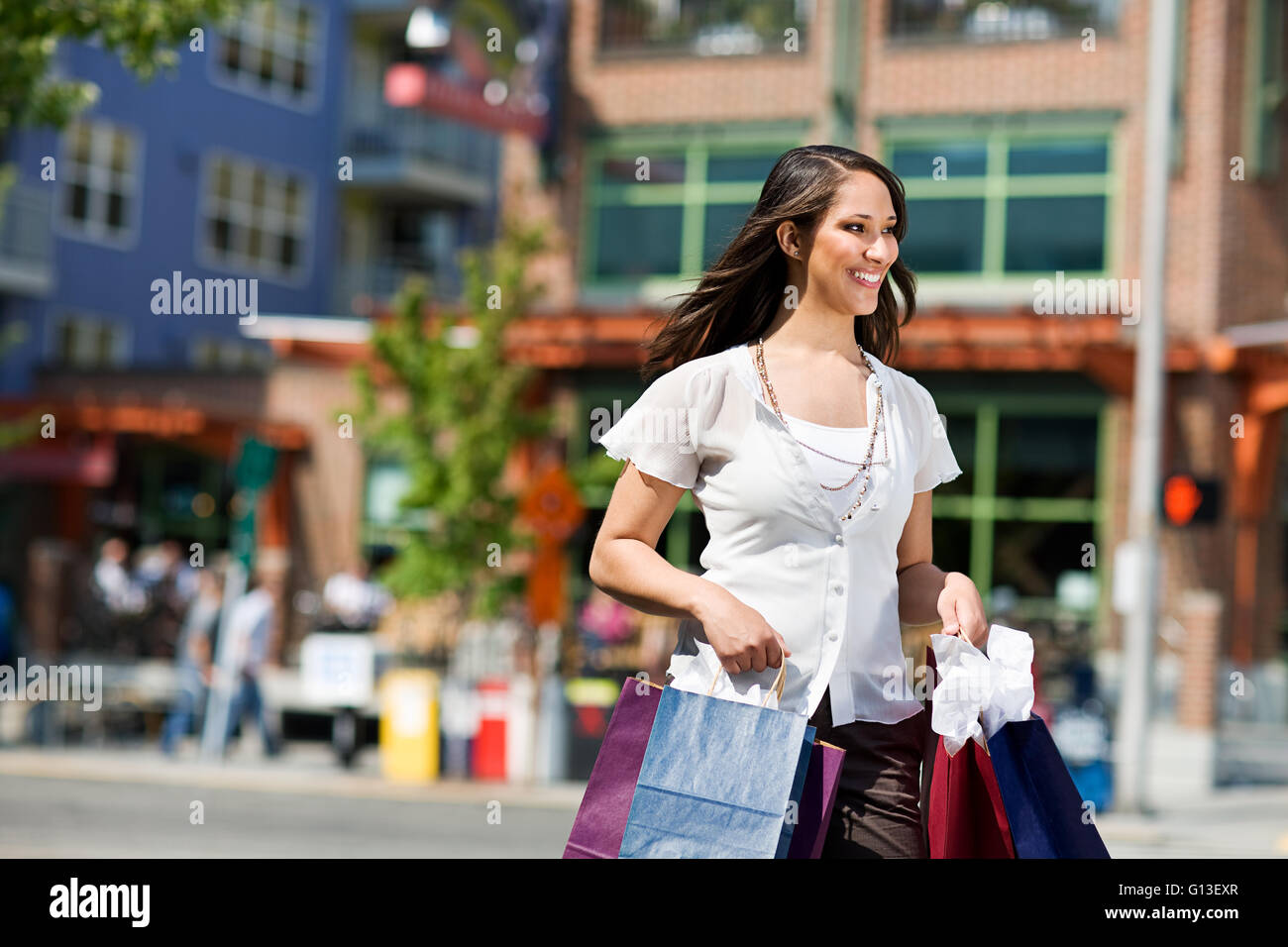 Couple going shopping in a colorful urban area Stock Photo - Alamy